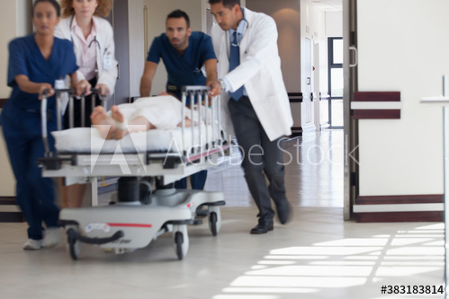 Free: Doctors and nurses rushing patient on stretcher in hospital ...