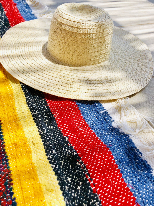 Free: Straw Hat on a Multi-colored Knitted Textile - nohat.cc