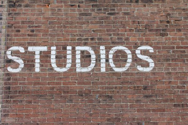 Free: Studios text on brown brick wall - nohat.cc